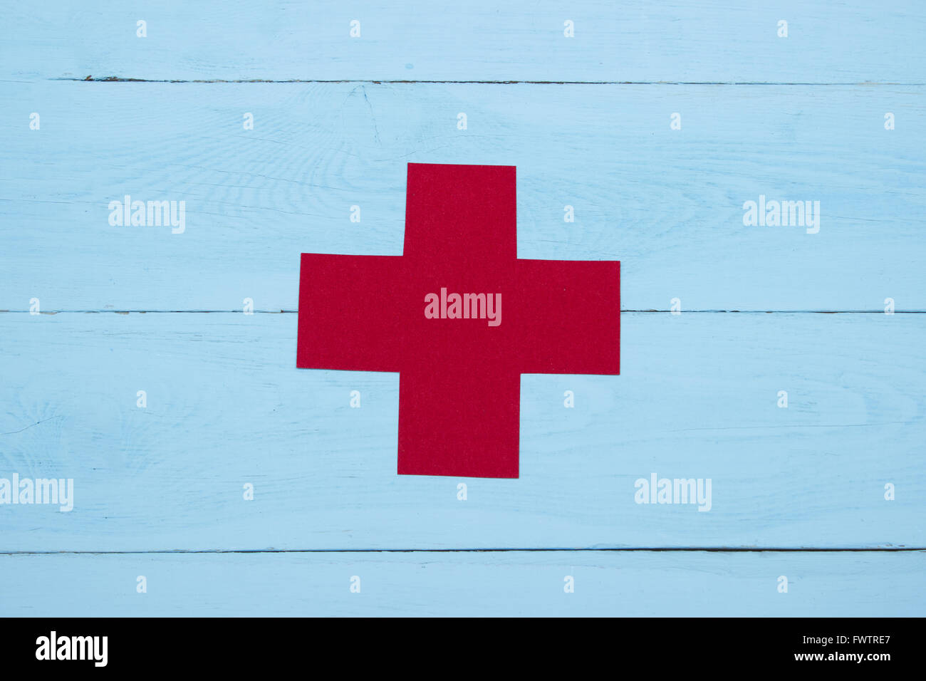 velvet paper red cross on a blue background of rough planks Stock Photo ...