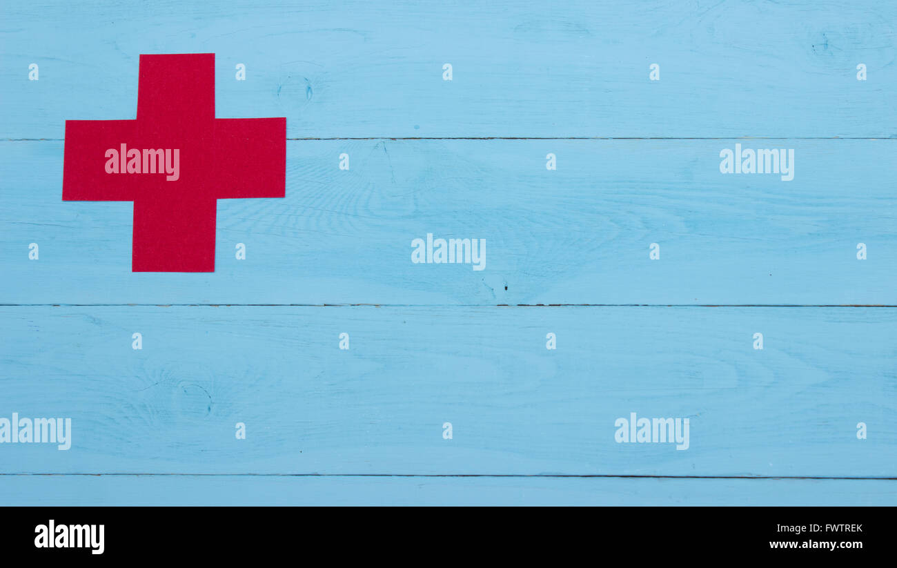 velvet paper red cross on a blue background of rough planks Stock Photo ...