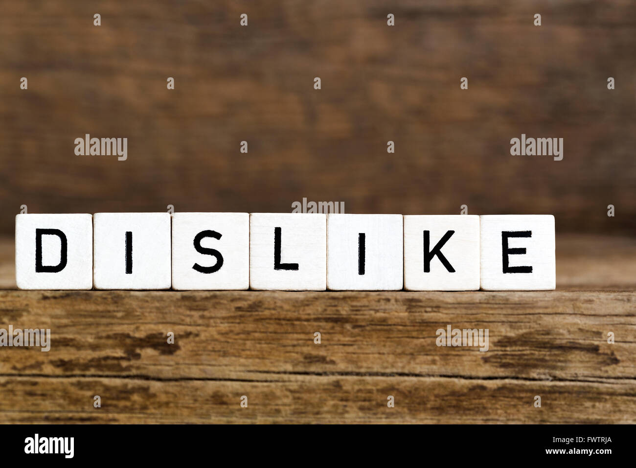 The word dislike written in cubes on wooden background Stock Photo - Alamy