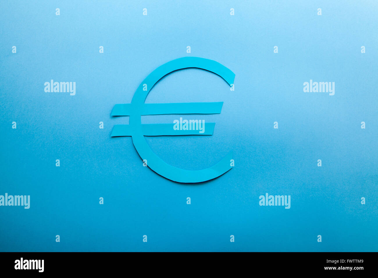 Blue euro symbol on a blue background with a soft light Stock Photo - Alamy