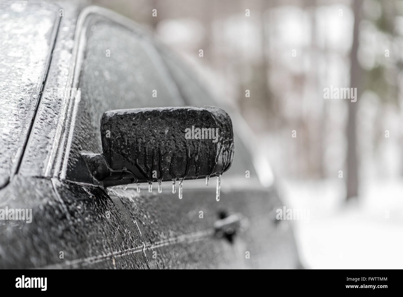 Freezing rain ice coated car. Black vehicle car covered in freezing ...