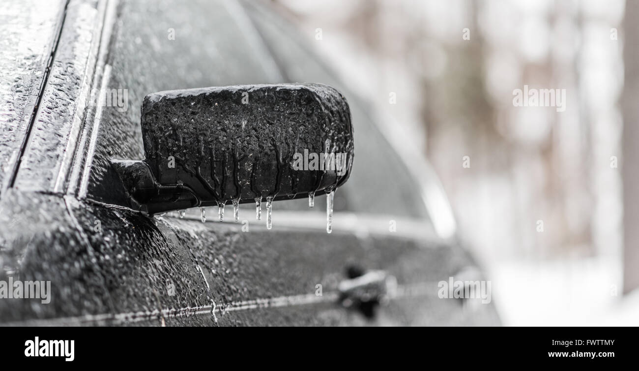 Freezing rain ice coated car. Black vehicle car covered in freezing ...