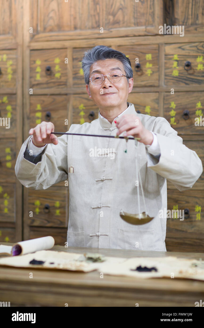 Senior Chinese doctor fill the prescription Stock Photo - Alamy