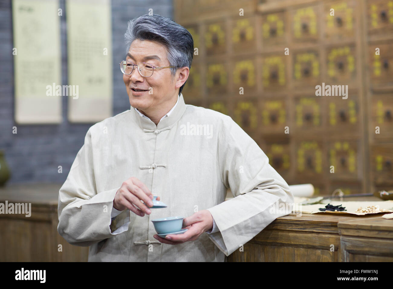 Senior Chinese doctor drinking tea Stock Photo - Alamy