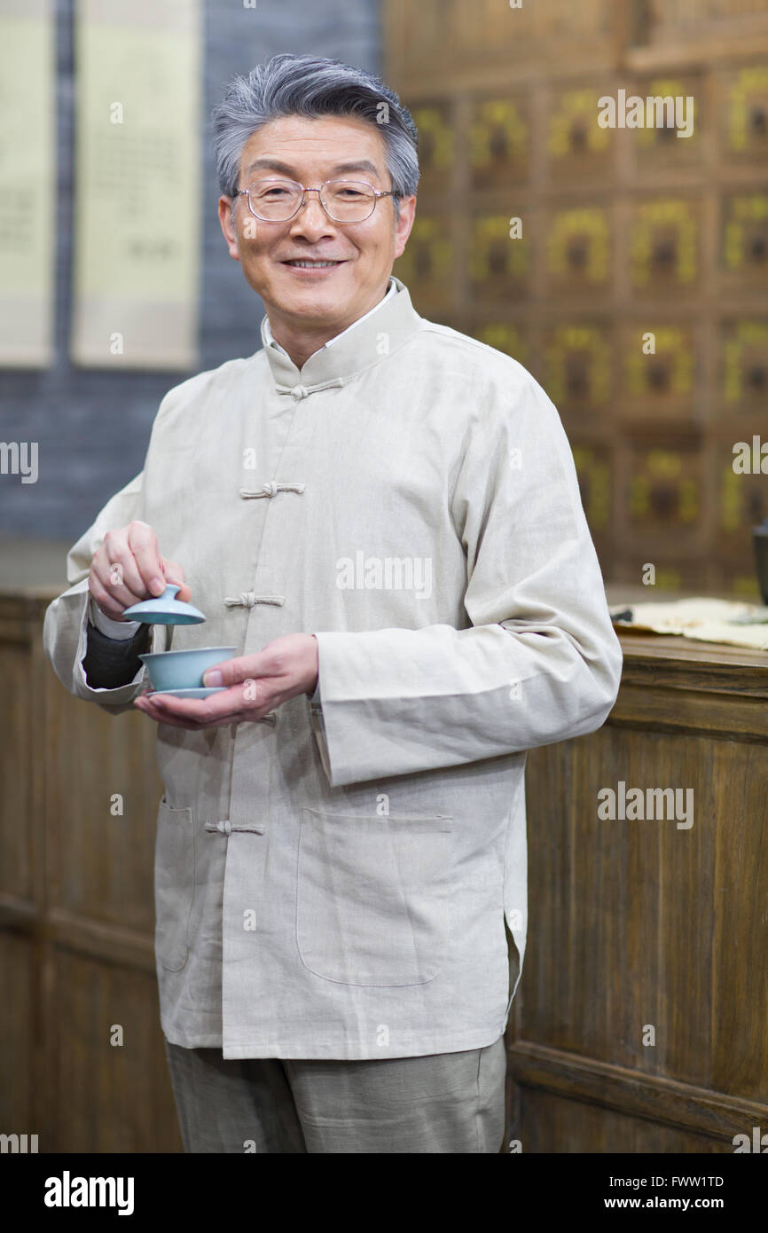 Senior Chinese doctor drinking tea Stock Photo - Alamy