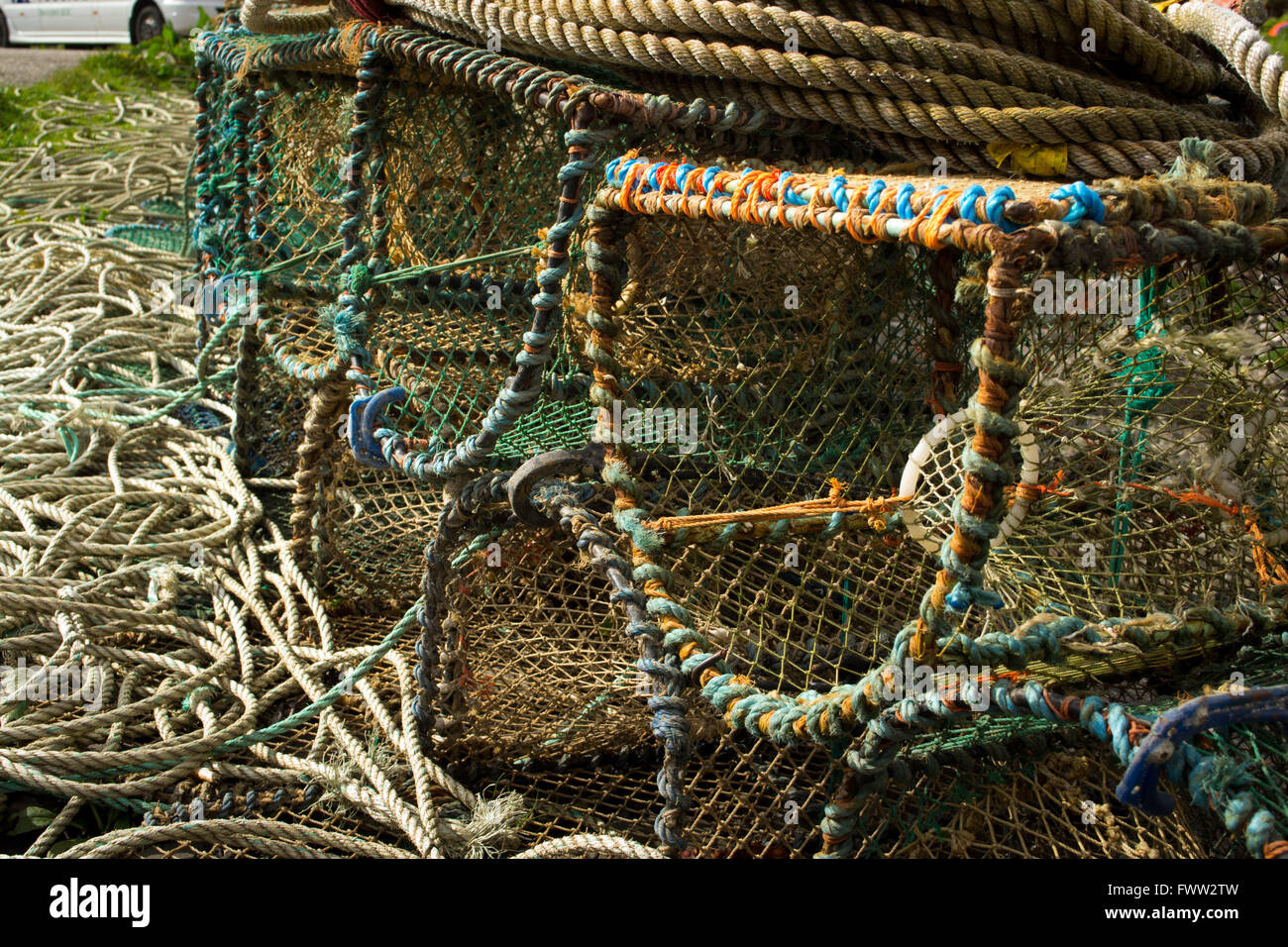 Fishing traps pilled up on the pier in a Scottish fishing town Stock ...