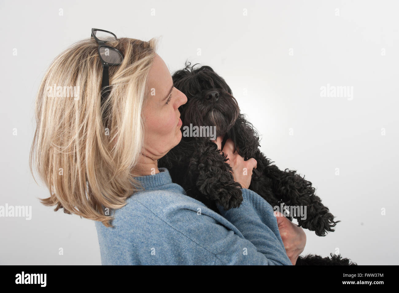 An attractive middle aged woman with her black cockapoo dog Stock Photo ...