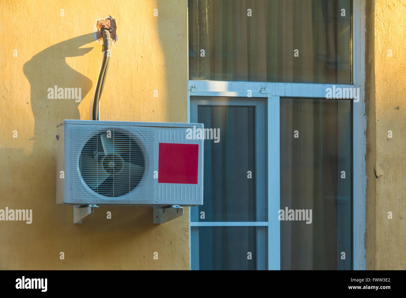 The window and the air conditioner on the facade of a apartment ...