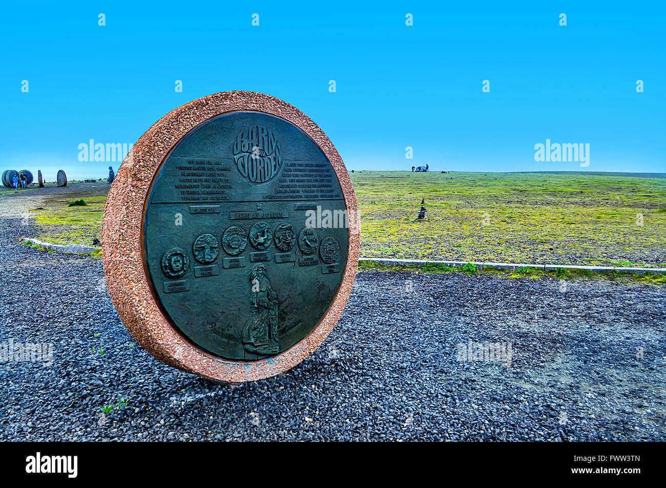 Monument of circle figure from red asphalt stone with black coin-shaped ...