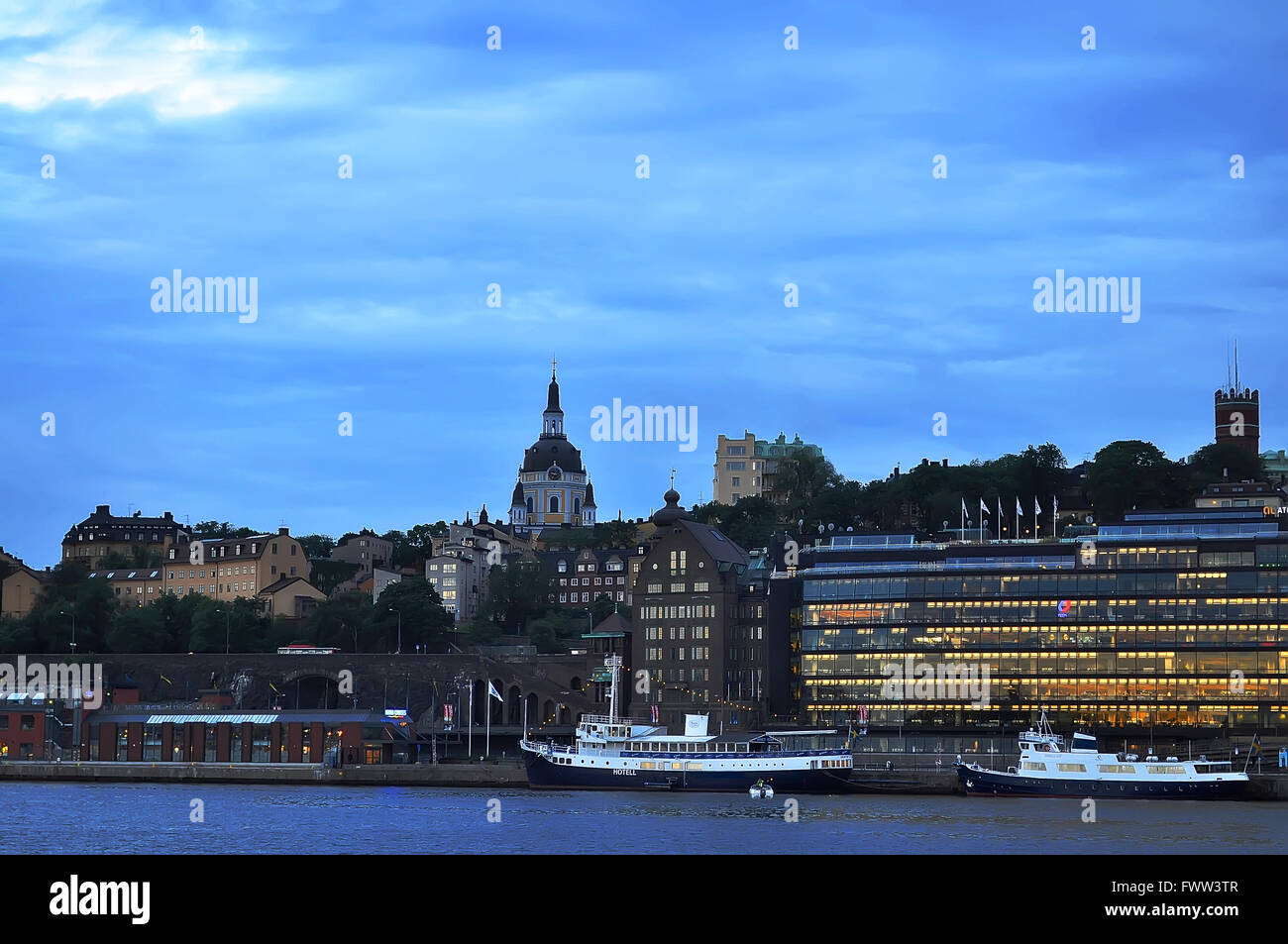 Jetty of port town with moored boats, buildings, church dome and the ...