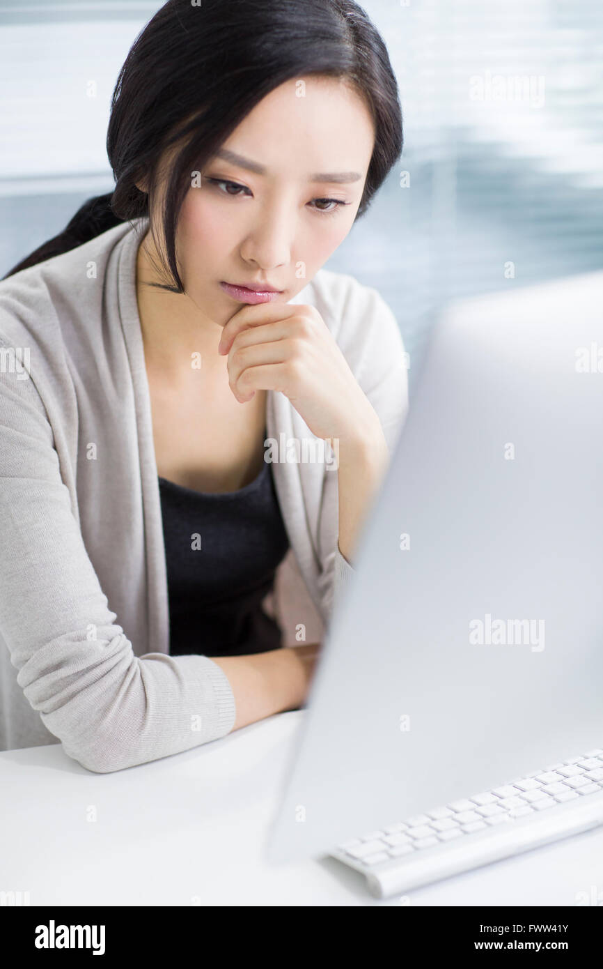Young woman working in office Stock Photo - Alamy
