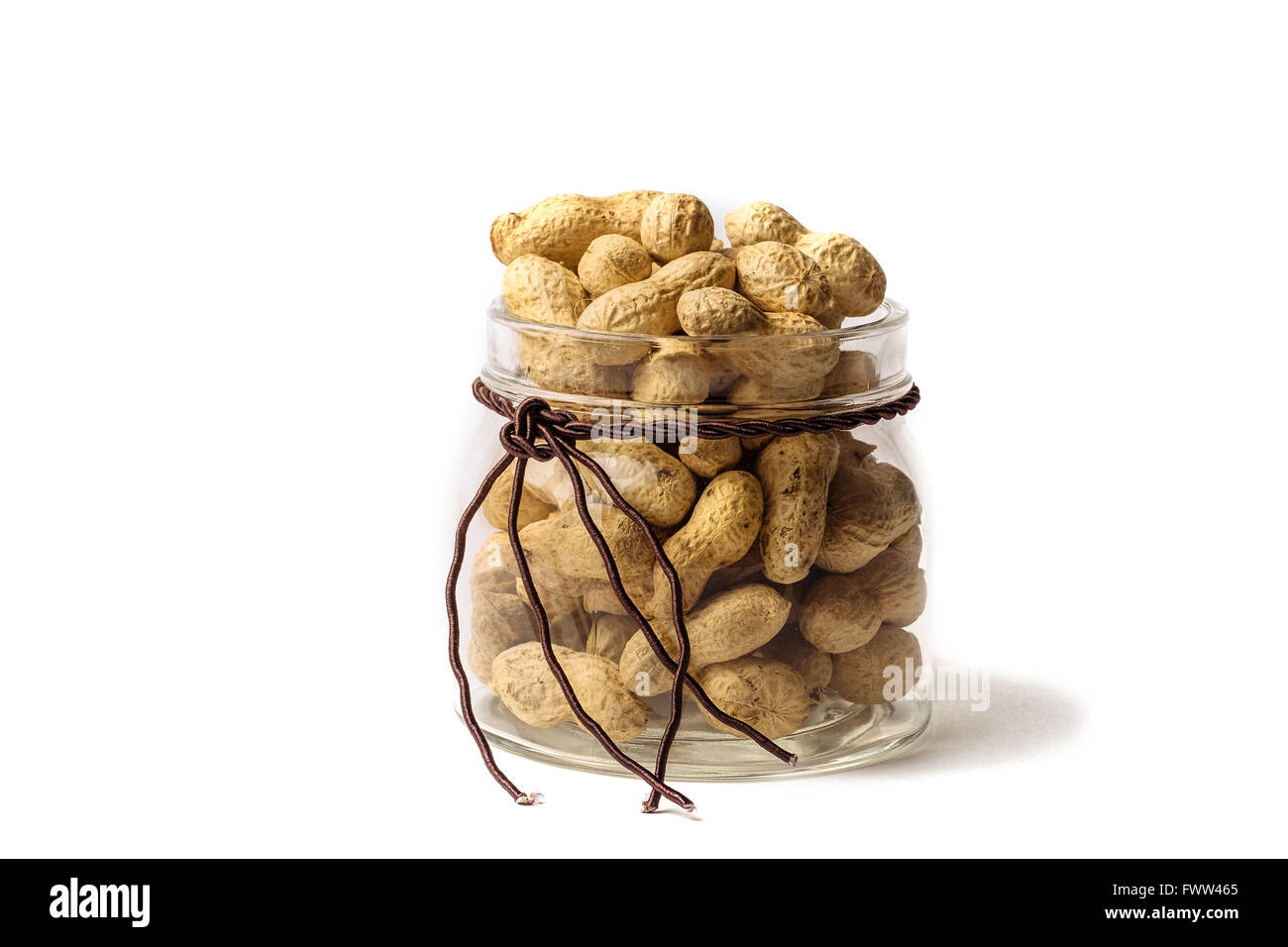 peanuts in glass jar on white background Stock Photo - Alamy