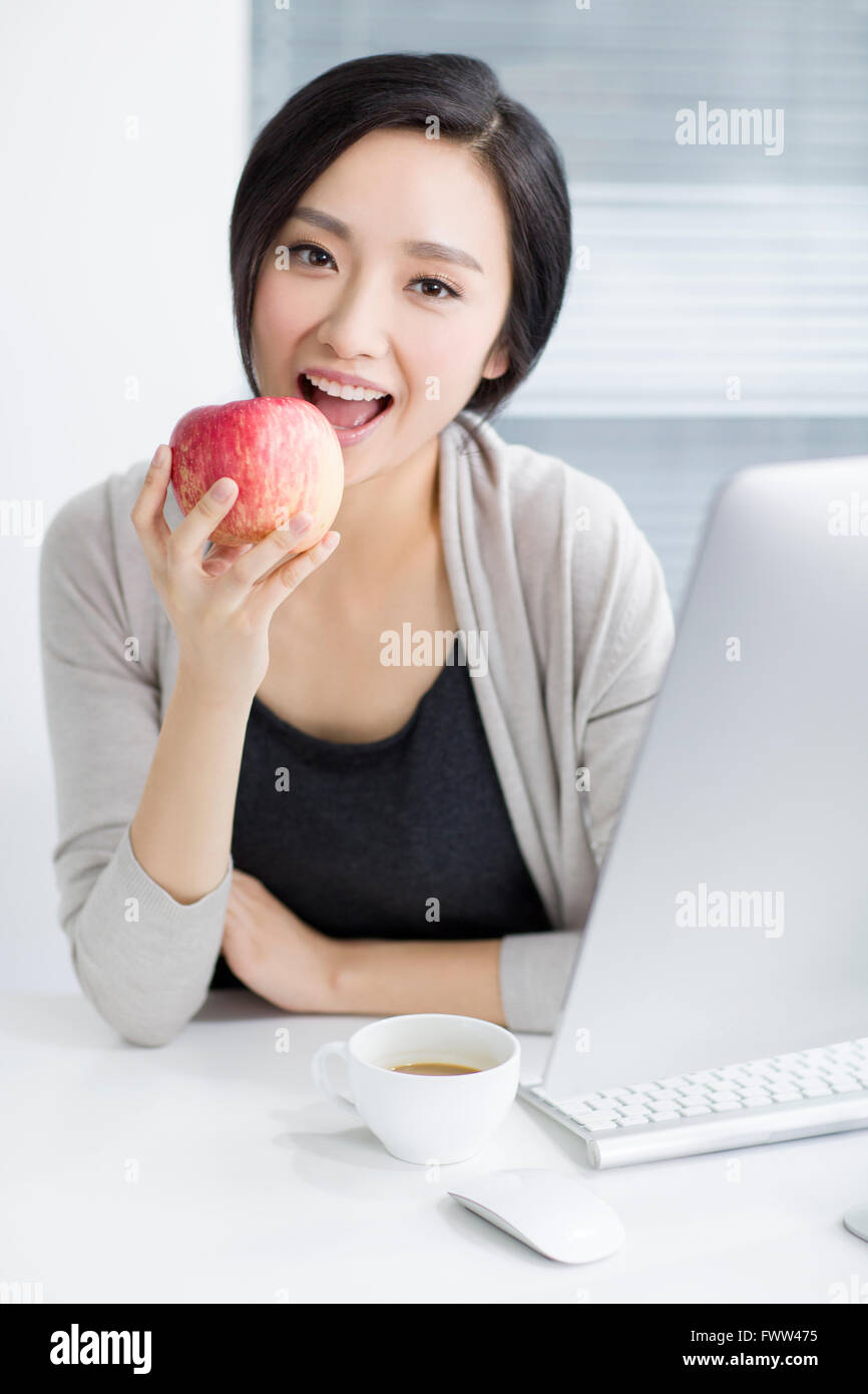 Young woman apple in mouth hi-res stock photography and images - Alamy