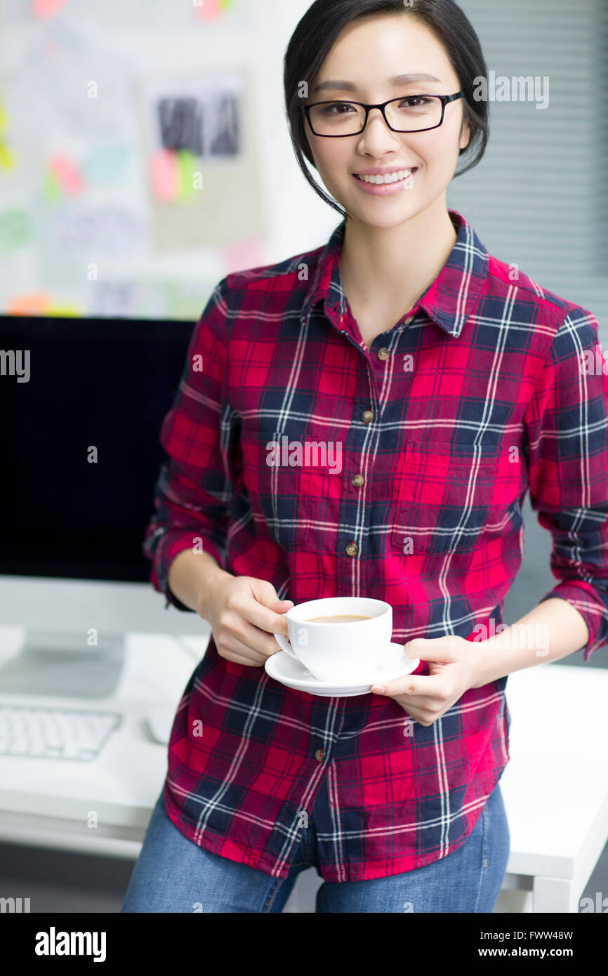 Young woman taking a coffee break Stock Photo - Alamy