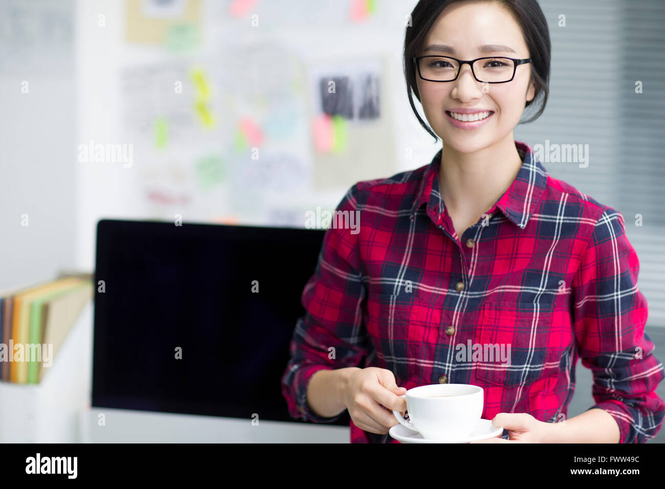 Young woman taking a coffee break Stock Photo - Alamy
