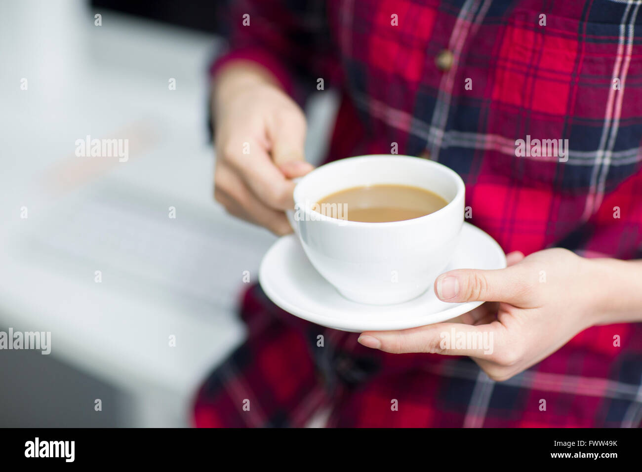 Young woman taking a coffee break Stock Photo - Alamy