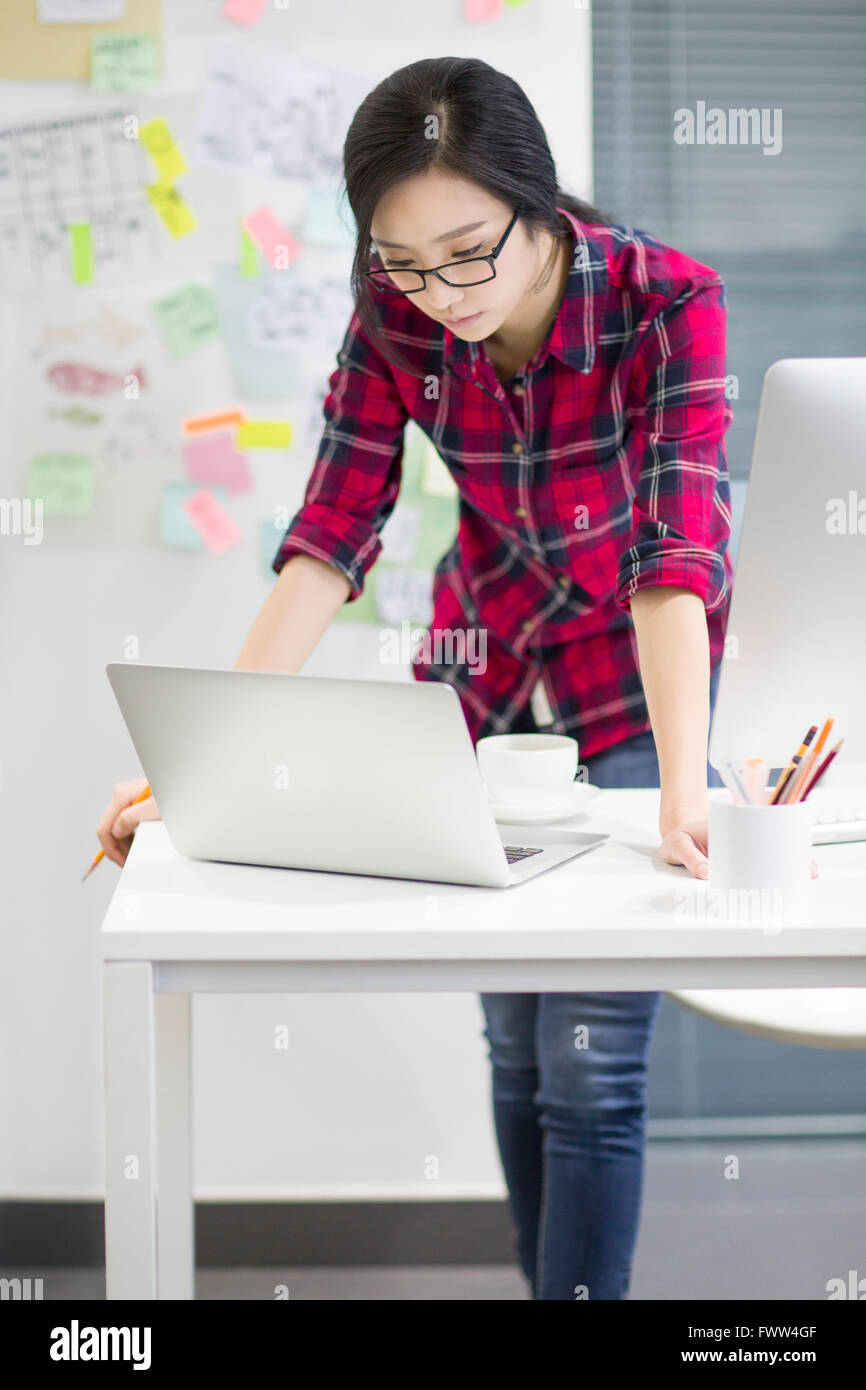 Female designer working in office Stock Photo - Alamy