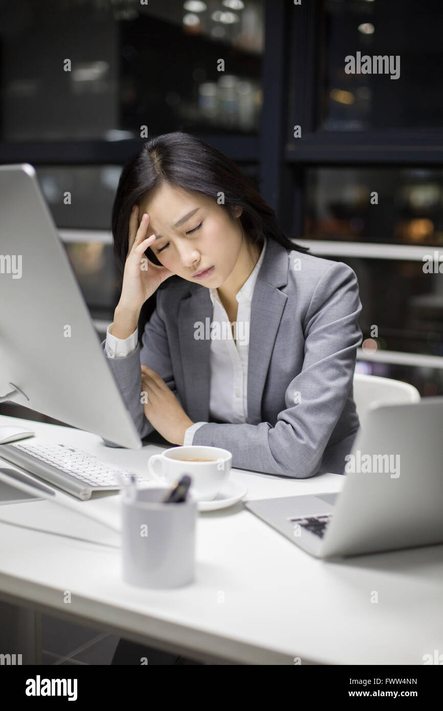 Businesswoman working late in office Stock Photo - Alamy