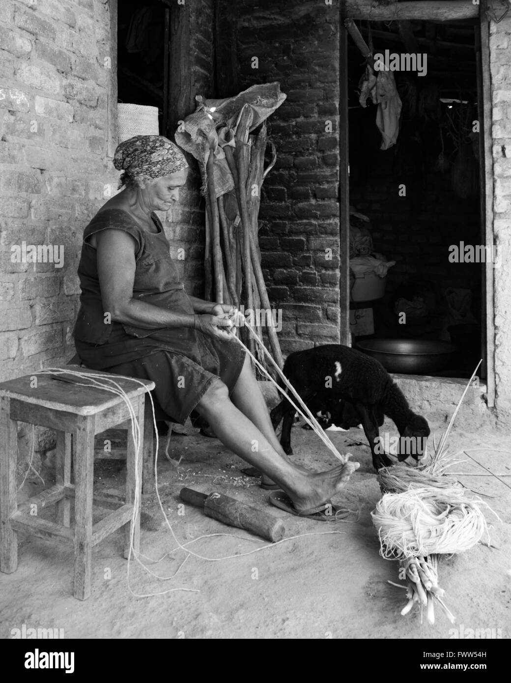 Black and white picture of a craftswoman working at home in a rustic ...