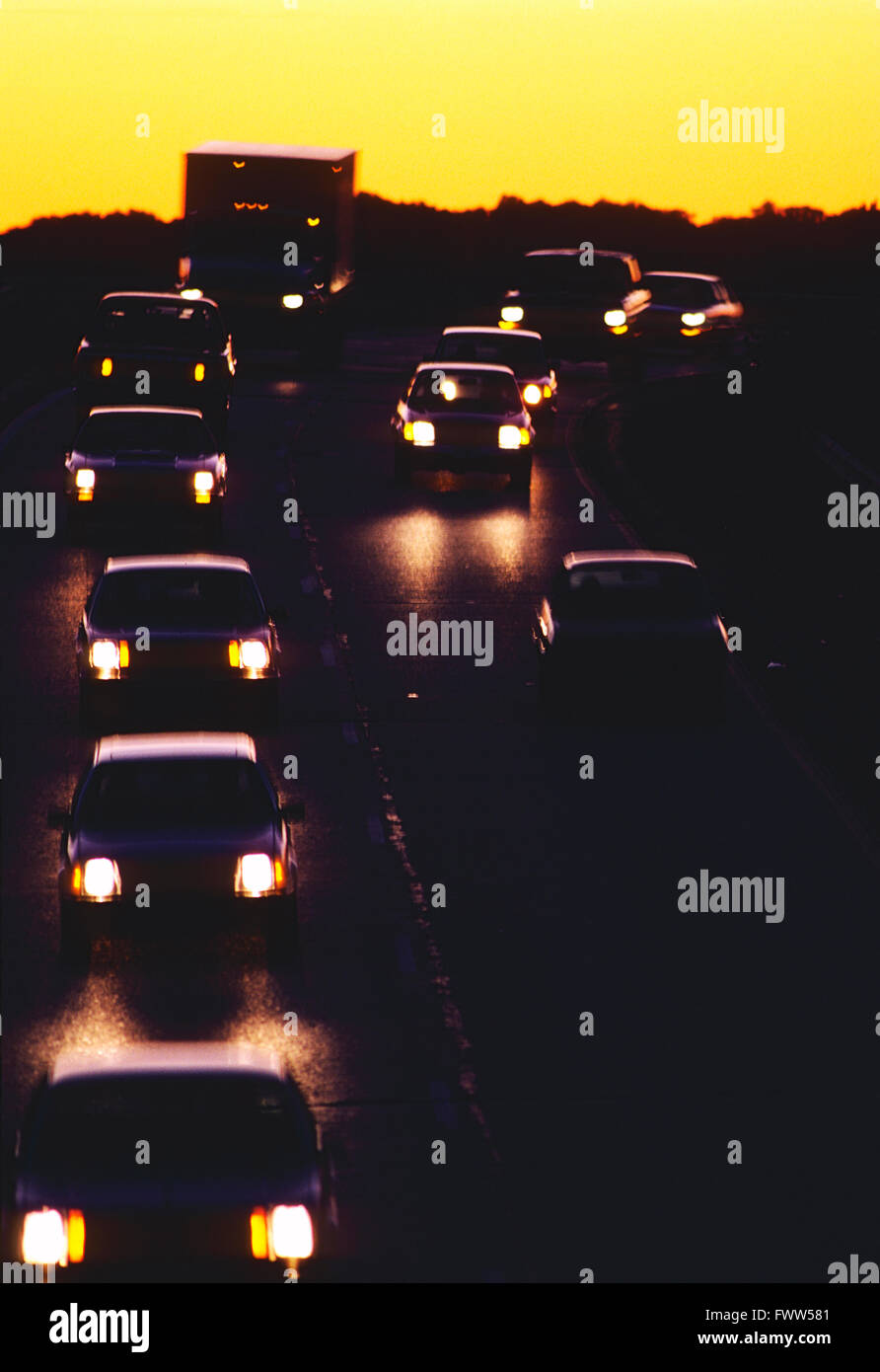 Headlights of oncoming highway traffic against sunset Stock Photo - Alamy