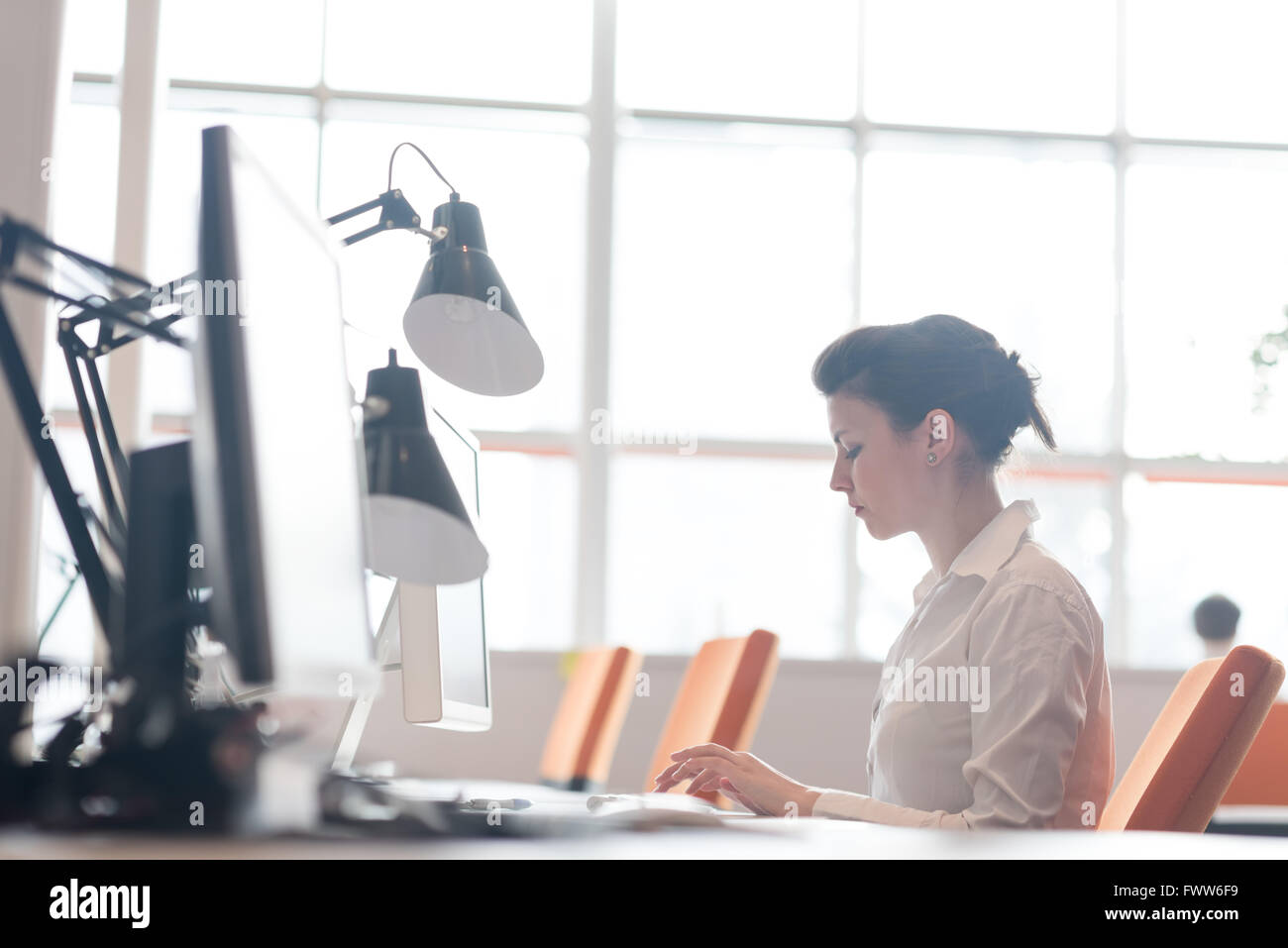 business woman working on desktop computer at modern startup office ...