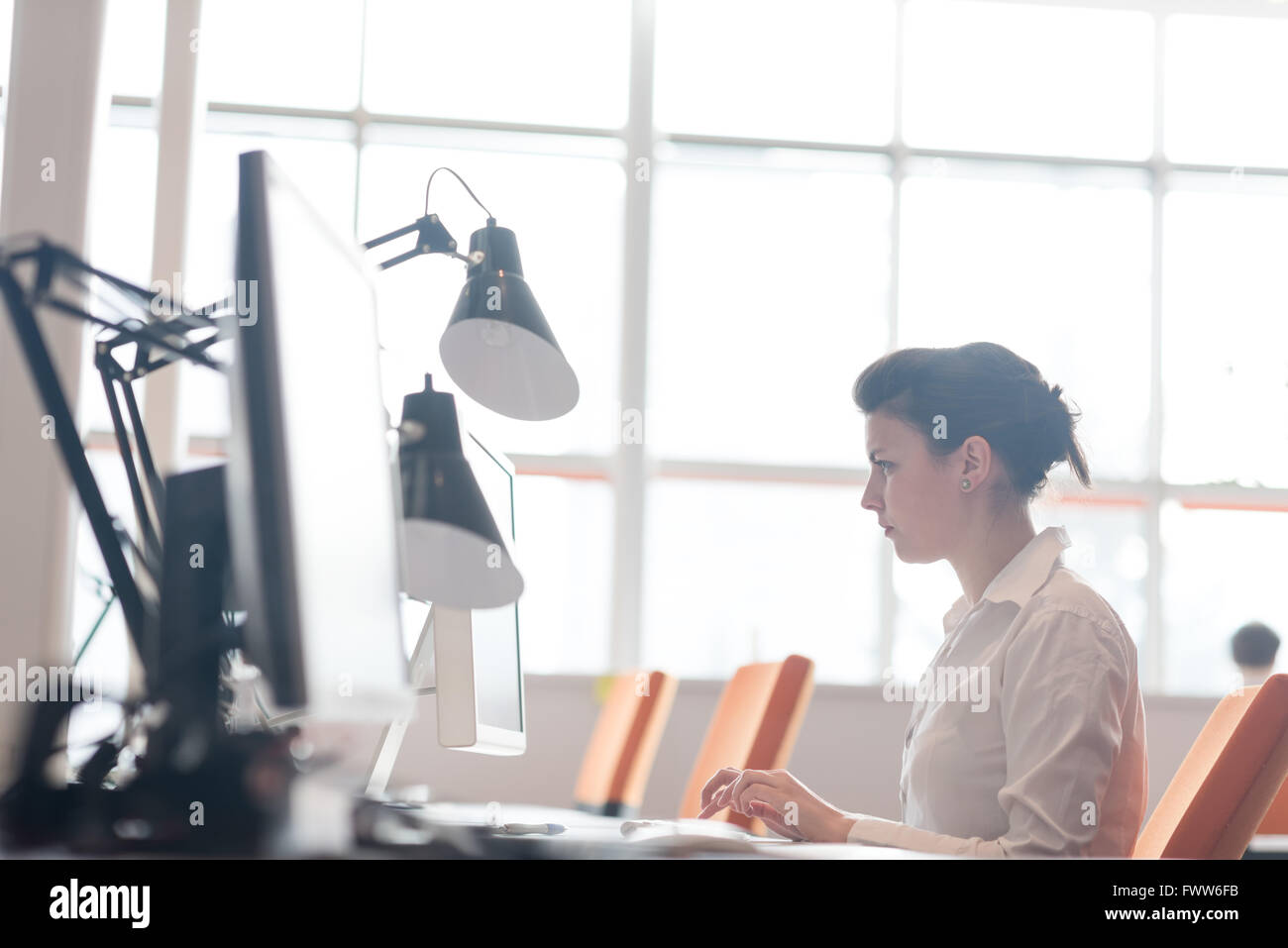 business woman working on desktop computer at modern startup office ...
