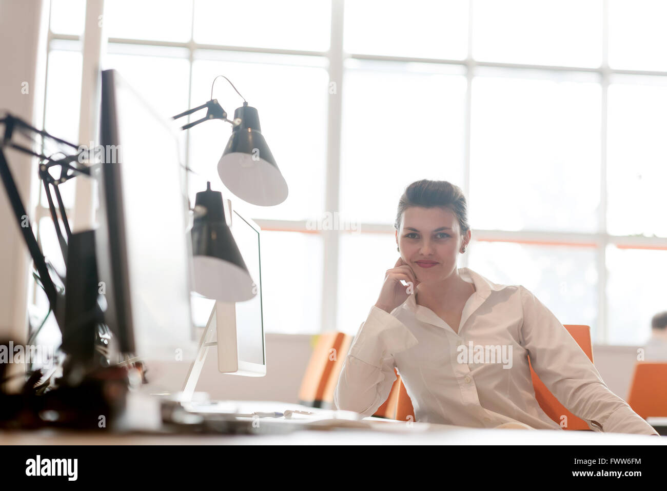 business woman working on desktop computer at modern startup office ...