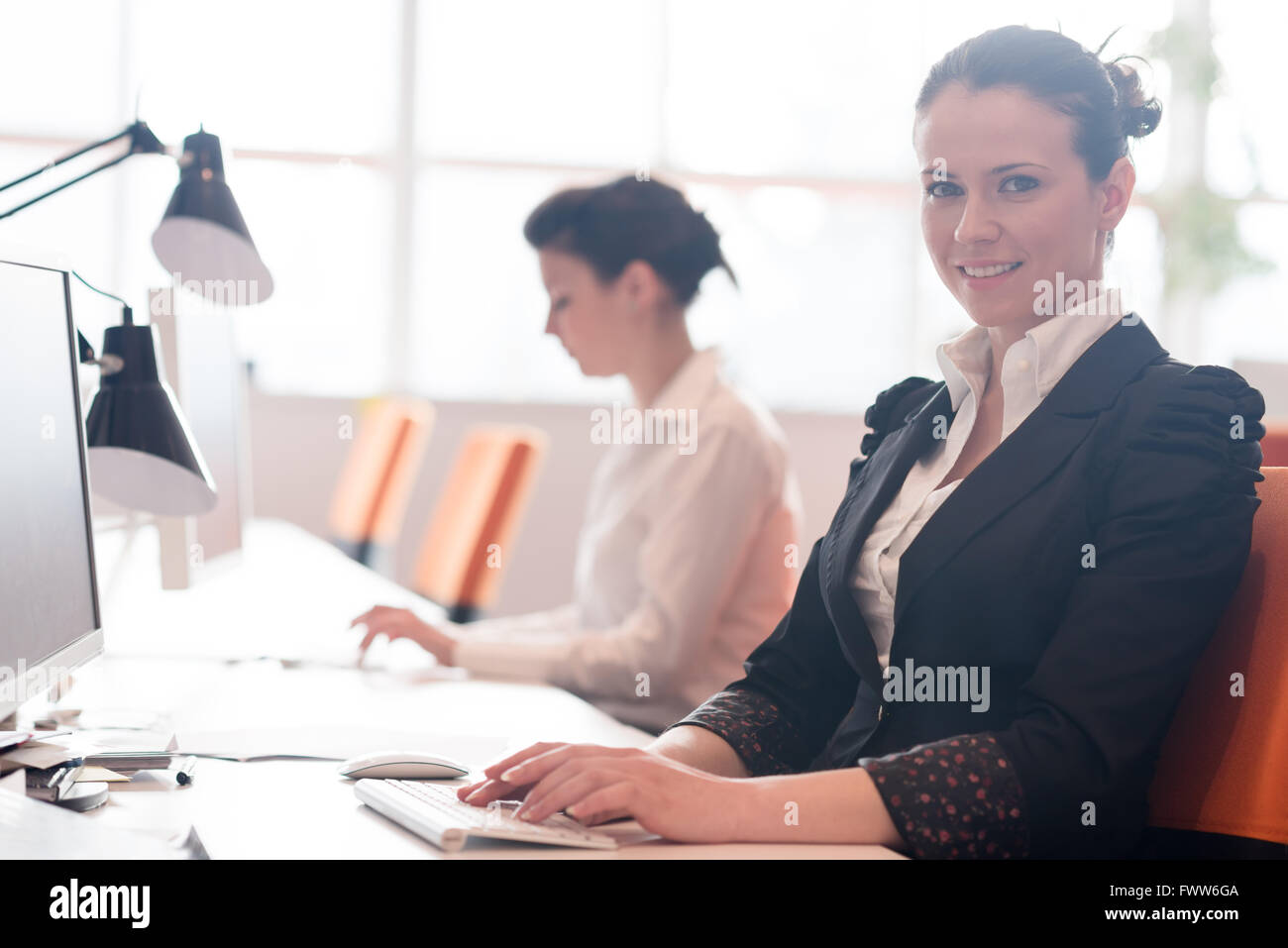 business woman working on desktop computer at modern startup office ...