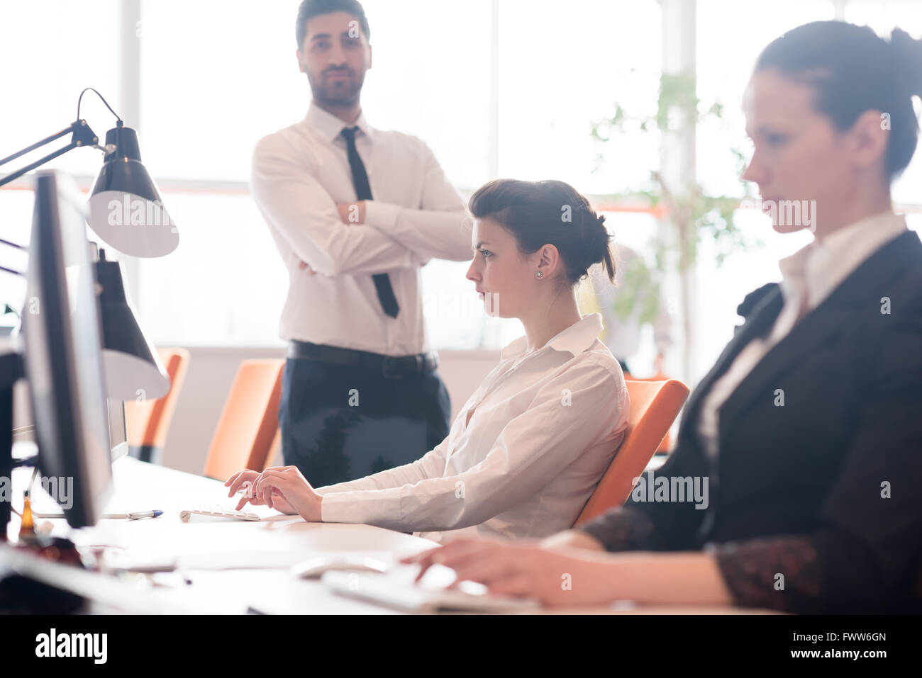 business woman working on desktop computer at modern startup office ...