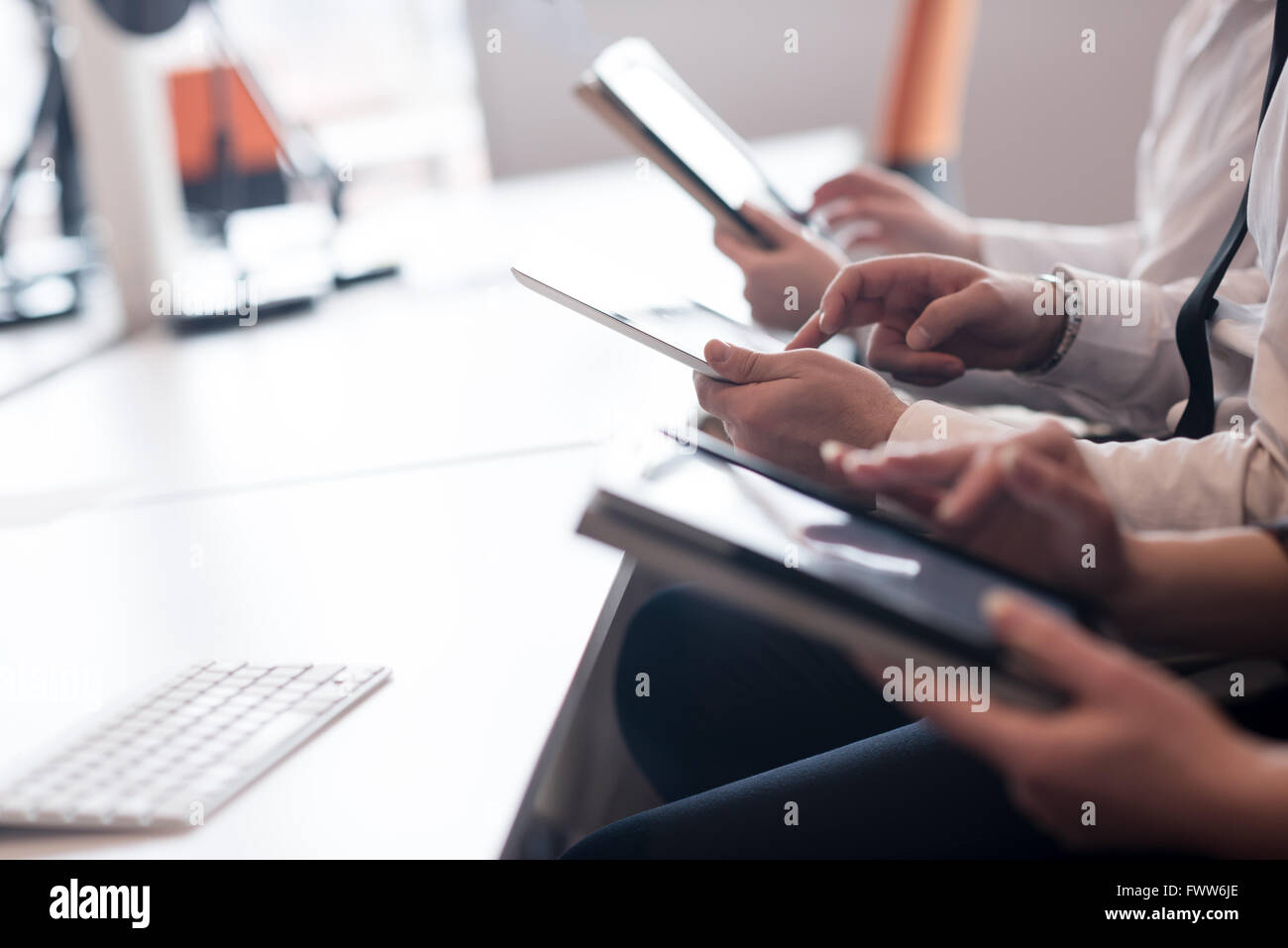 group of business people on meeting using tablet computer in modern ...