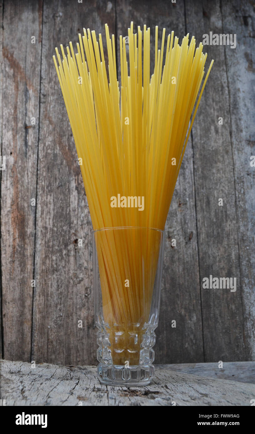 stack of spaghetti on rustic wood Stock Photo - Alamy