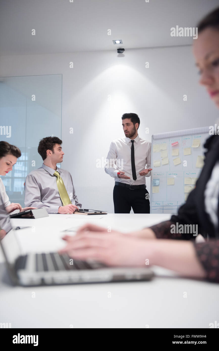 young business woman on meeting usineg laptop computer, blured group of ...