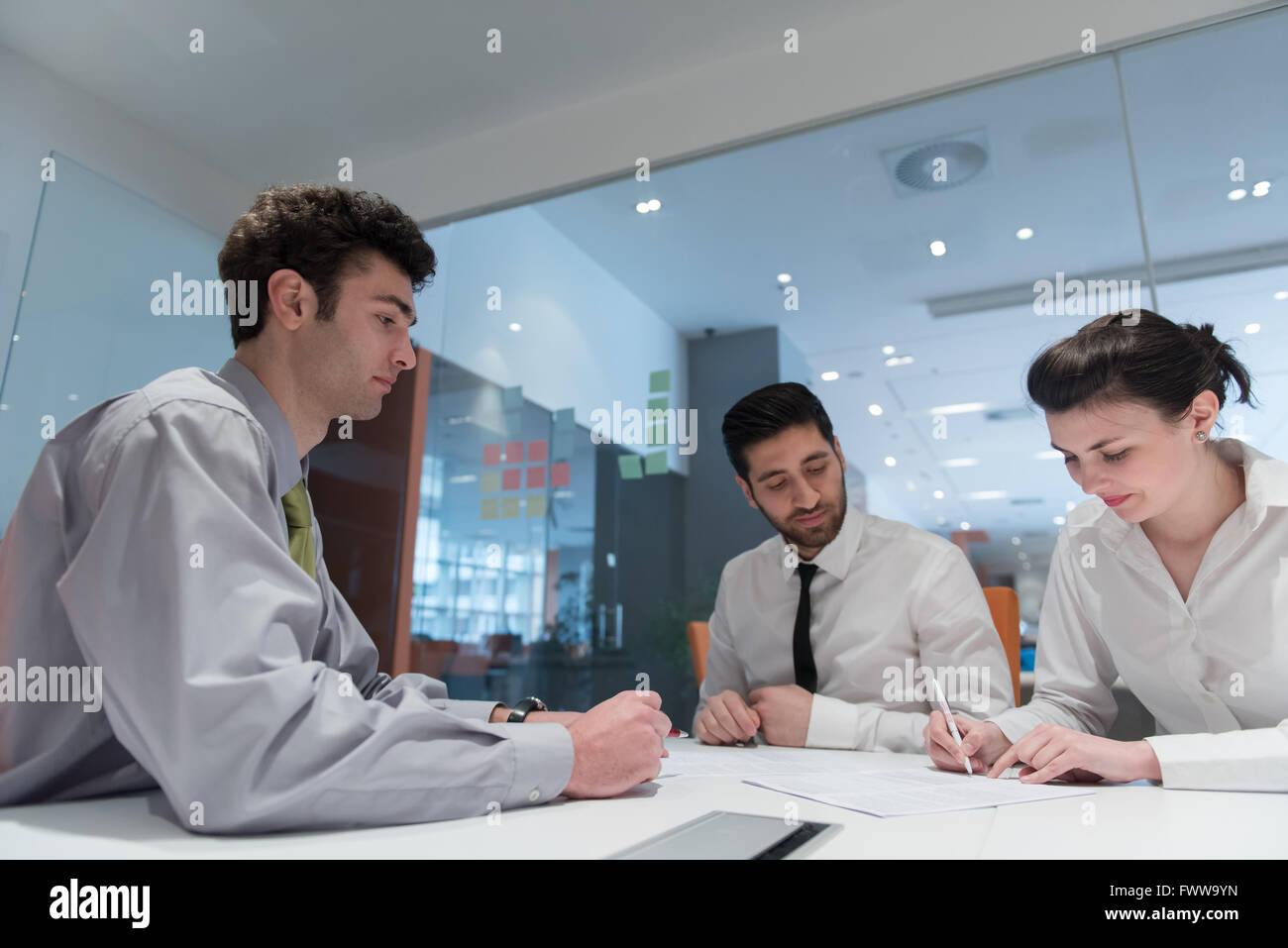 signing contract on partners back, young couple on business meeting ...