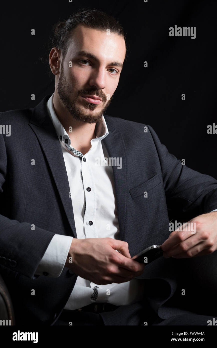 Young man holding smart phone Stock Photo - Alamy