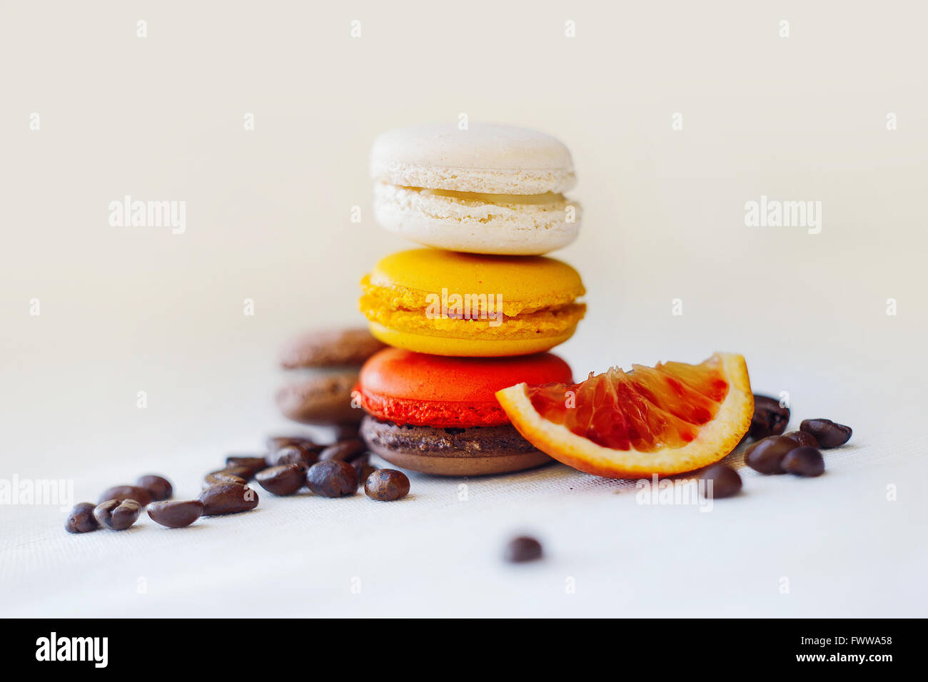 Colorful macaroons tower close-up on black background. Taste of coffee ...