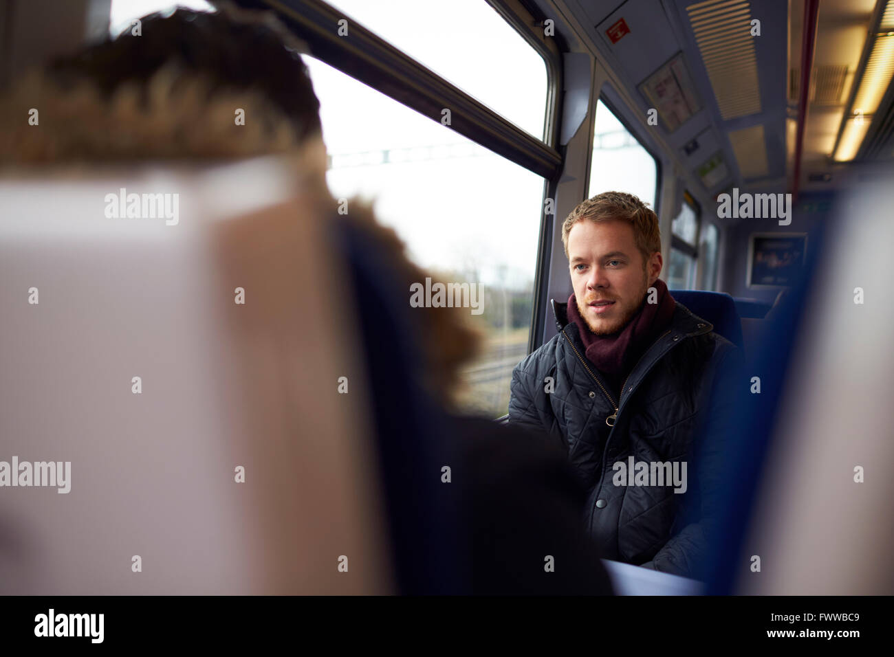 Two Men Sitting In Train Carriage And Talking Stock Photo - Alamy