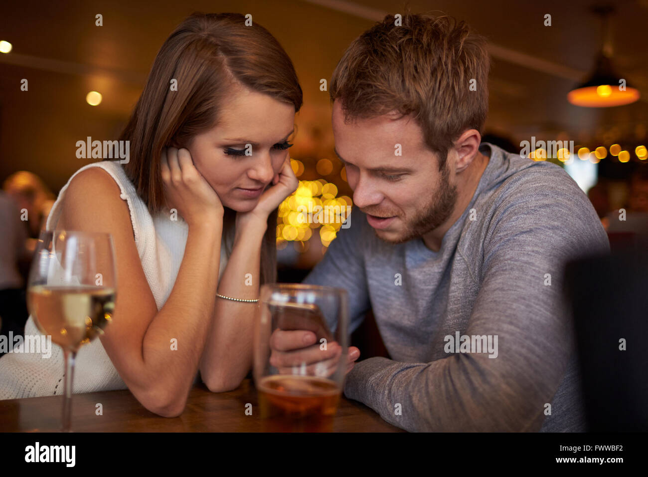 Romantic Couple Sitting And Talking In Wine Bar Together Stock Photo ...