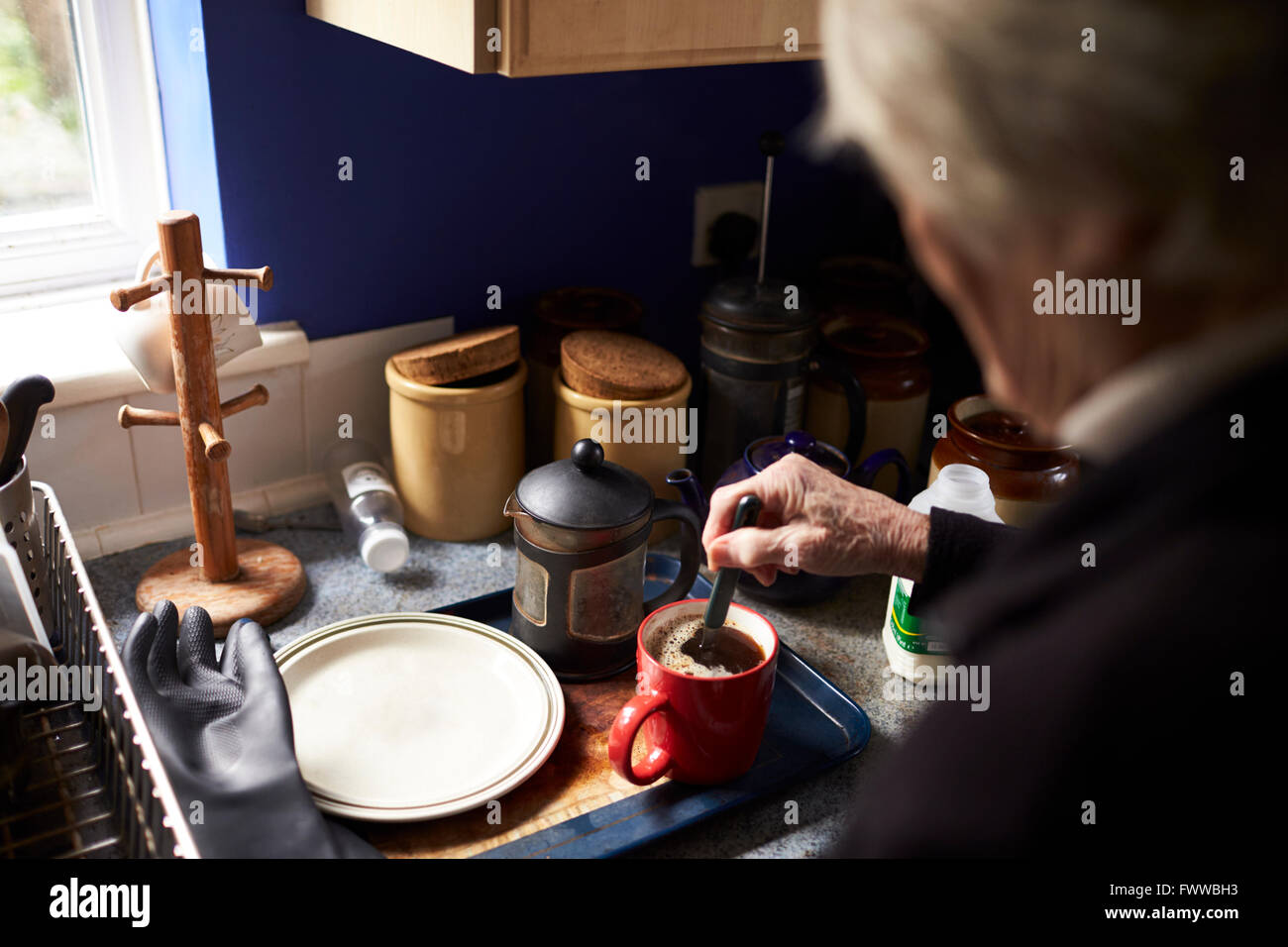 Senior Woman Making Hot Drink In Kitchen Stock Photo - Alamy