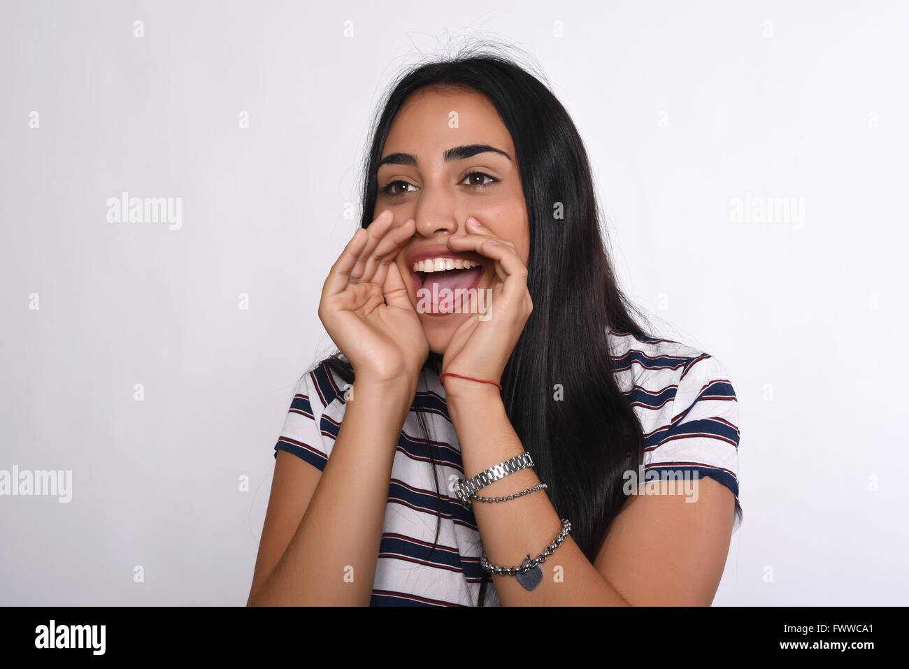 Beautiful young woman shouting and screaming. Isolated white background ...