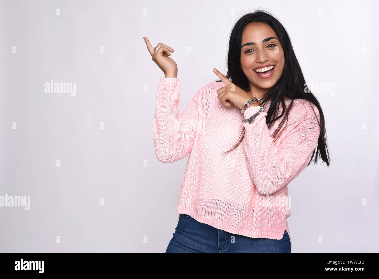 Young beautiful woman pointing at white background Stock Photo - Alamy