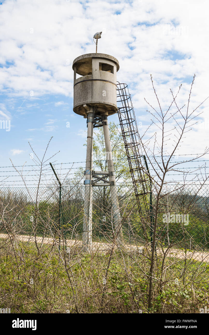 Abandoned watchtower isolated by a net topped with barbed wire Stock ...