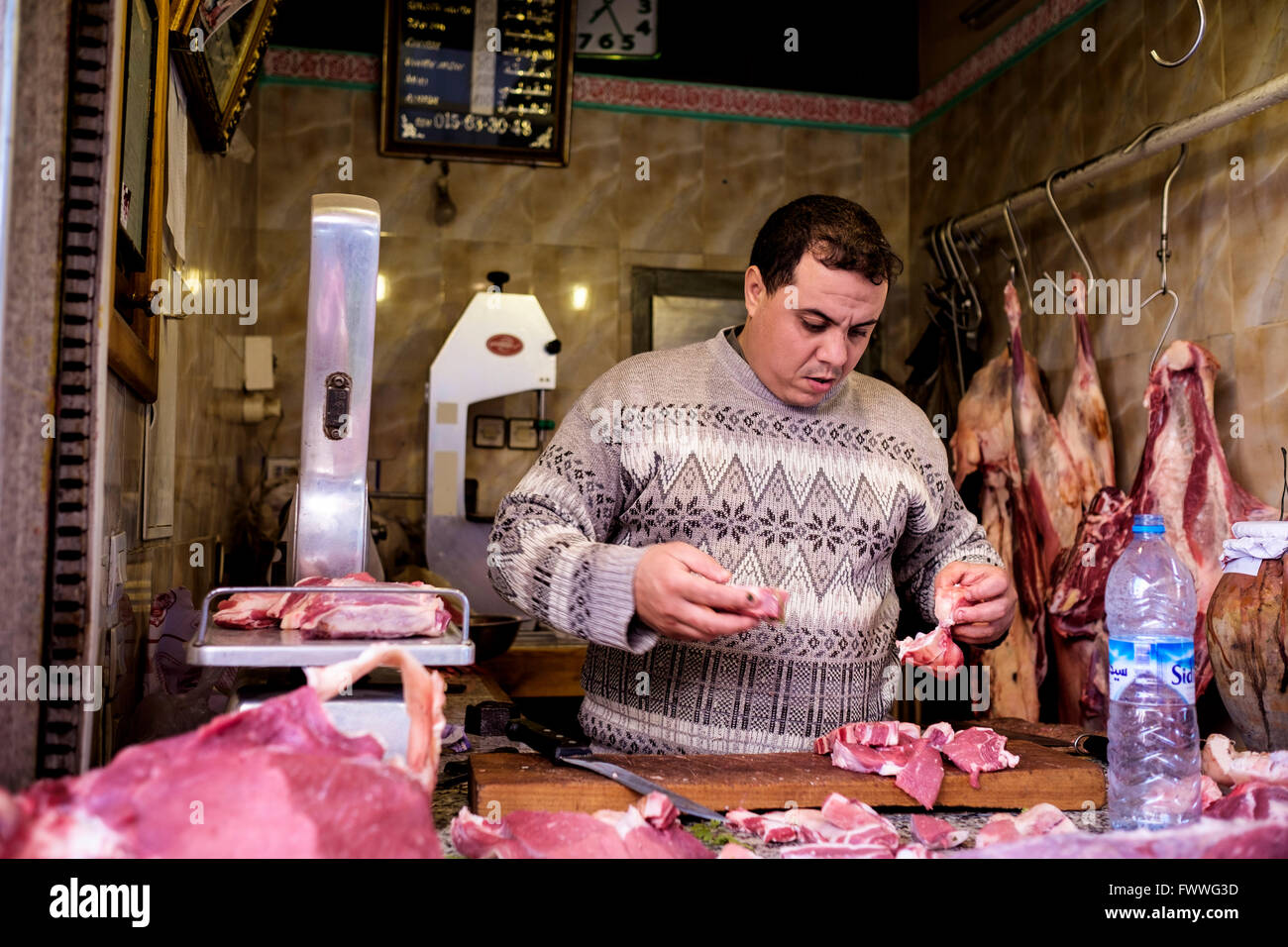 A butcher at work in his shop in the medina in Marrakech, Morocco ...