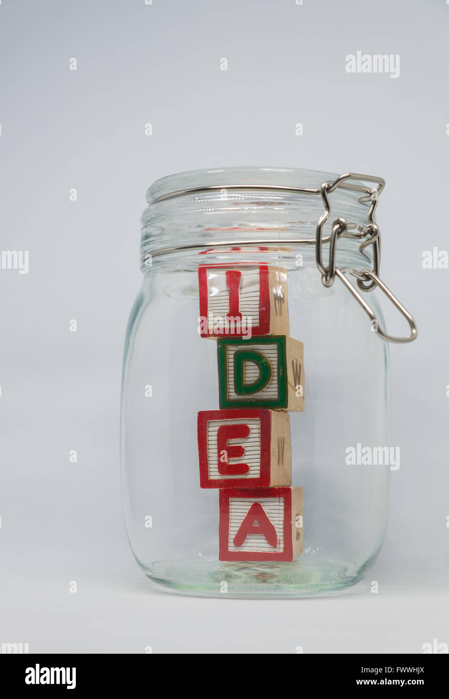 Wooden block IDEA word in the glass bottle with white background in ...