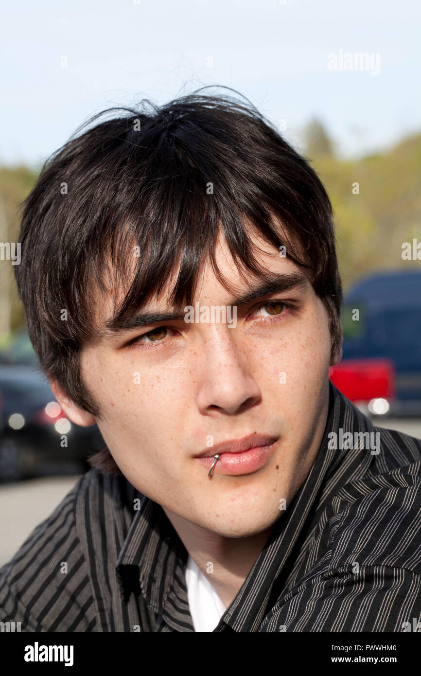 Young Caucasian teen boy outdoor portrait black hair Stock Photo - Alamy