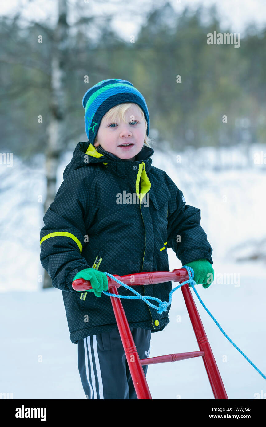 Young boy with kick-sled Stock Photo - Alamy