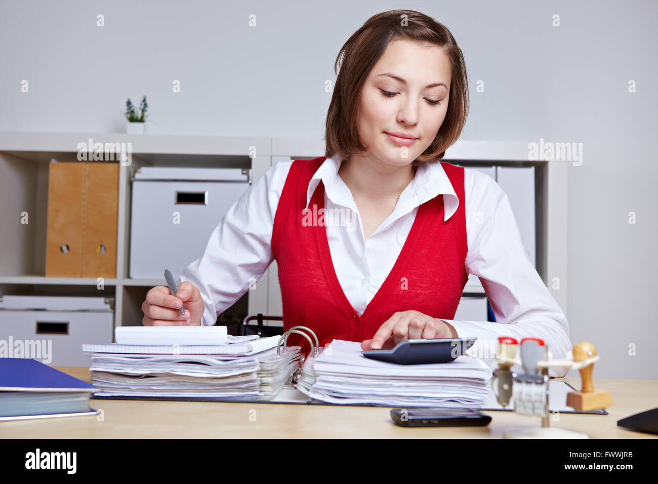 Business woman doing a tax audit in the office with files and ...