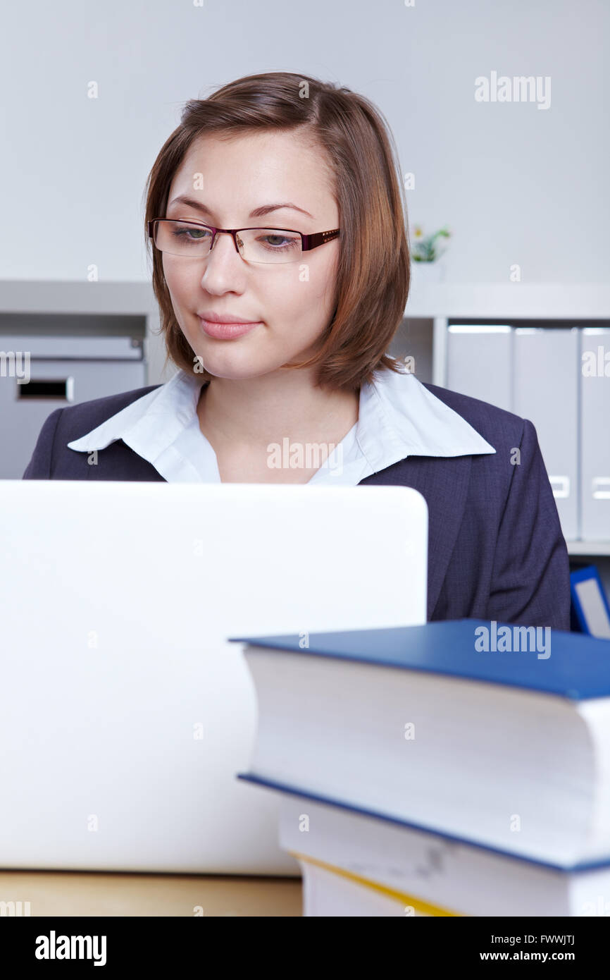 Attractive female laywer working at laptop computer in the office Stock ...