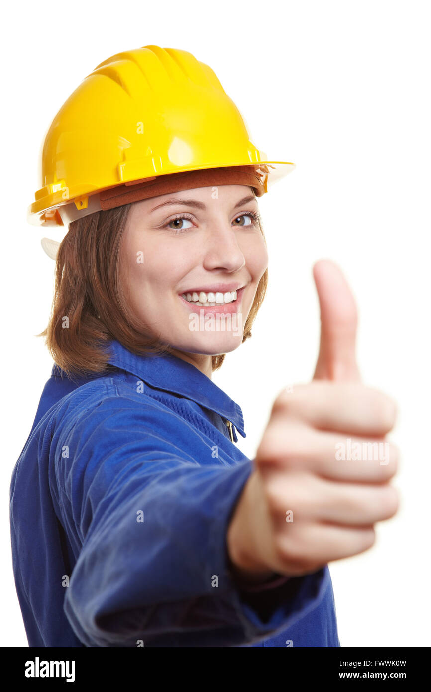 Happy female worker in blue overall and hardhat holding thumbs up Stock ...