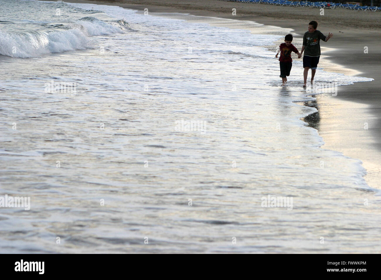 brothers running along beach Stock Photo - Alamy