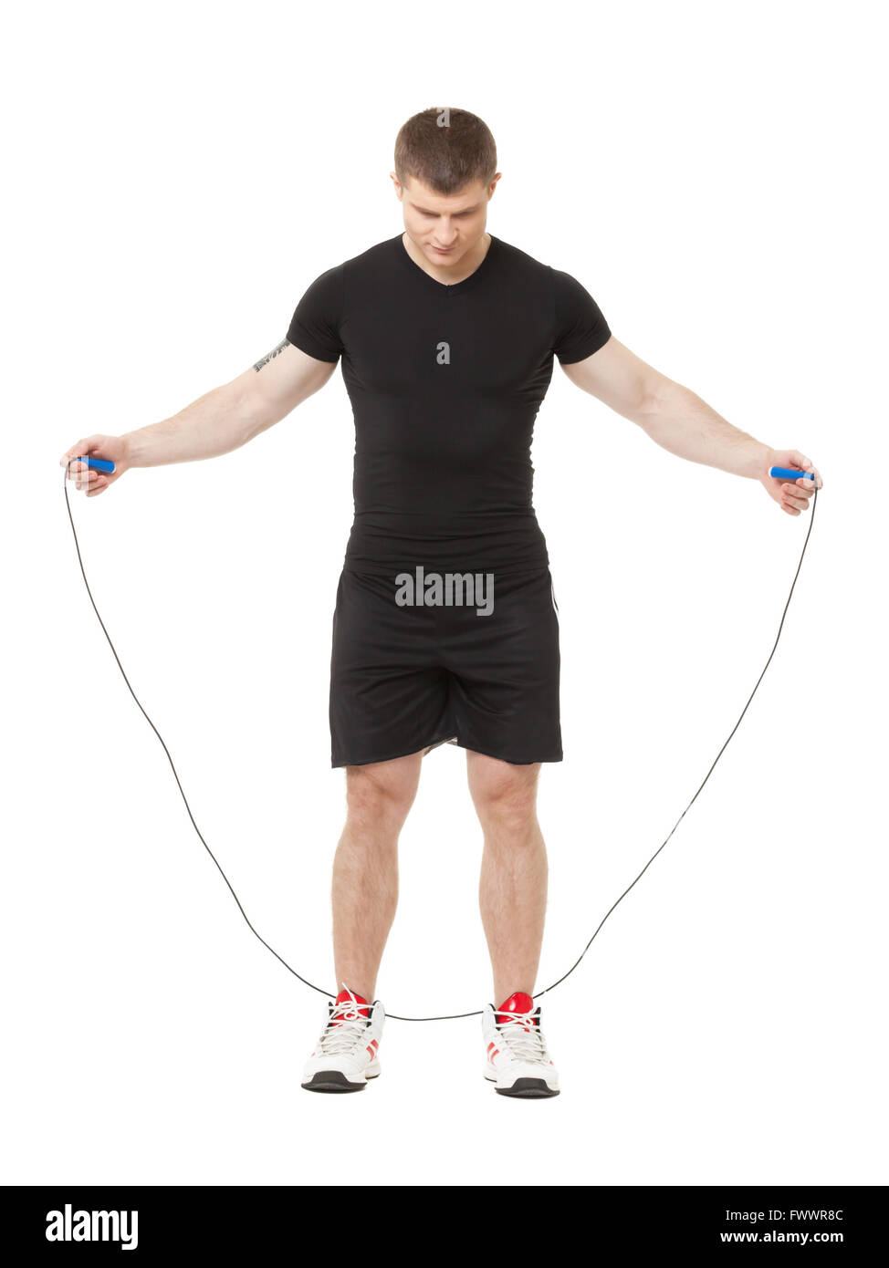 Young male jumping with jumping rope isolated at white background Stock ...